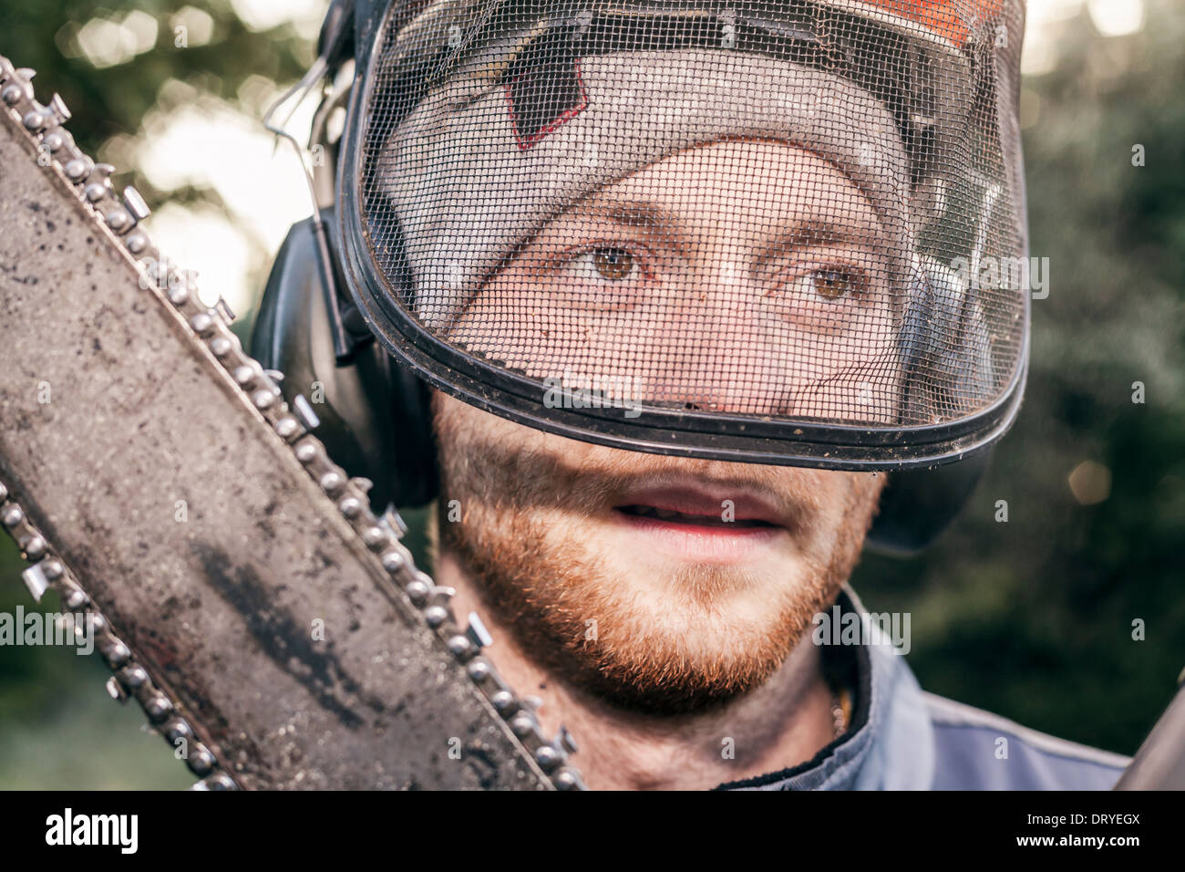 Portrait of professional gardener with chainsaw Stock Photo - Alamy
