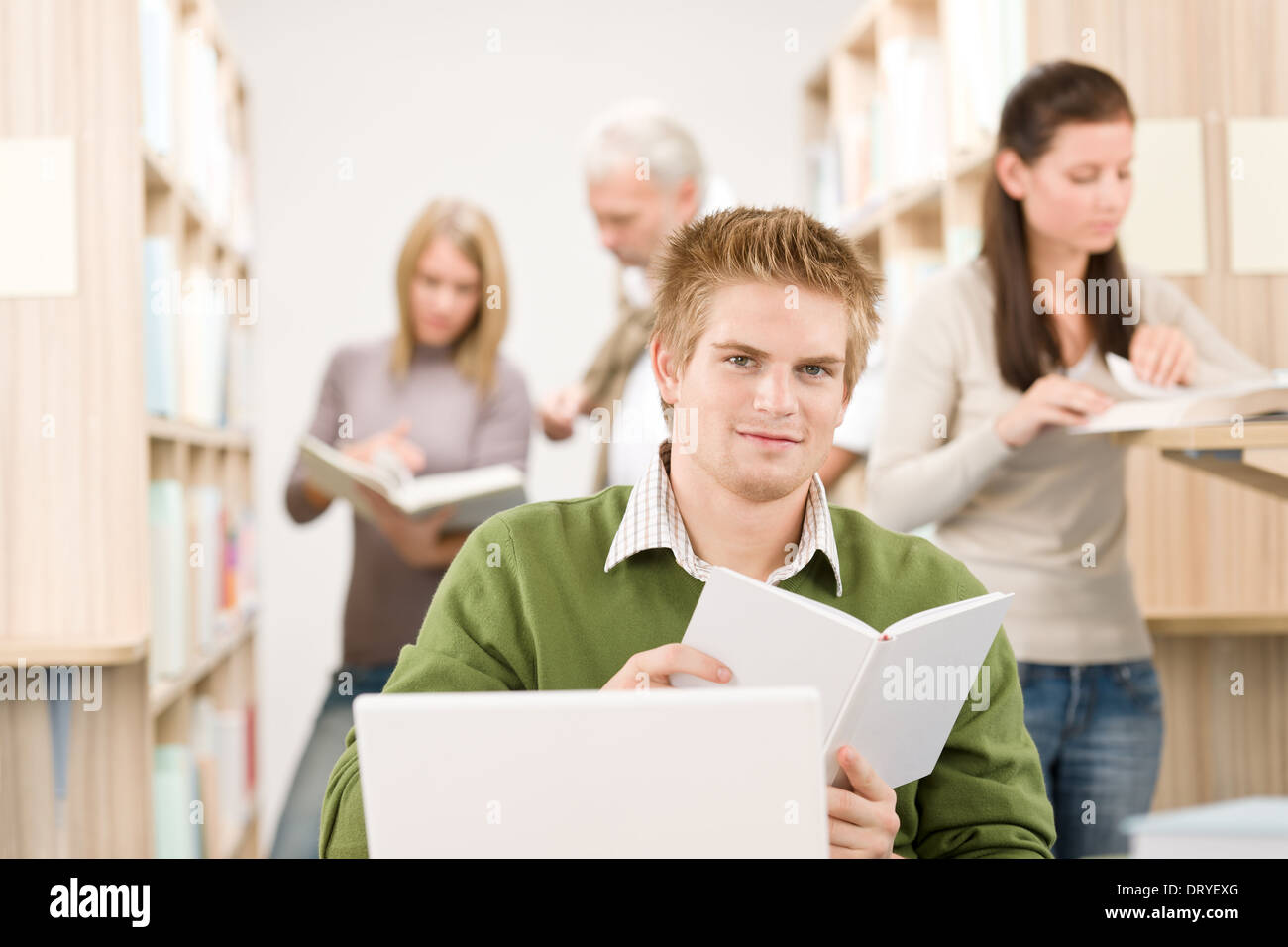 High school library - Student with book Stock Photo - Alamy