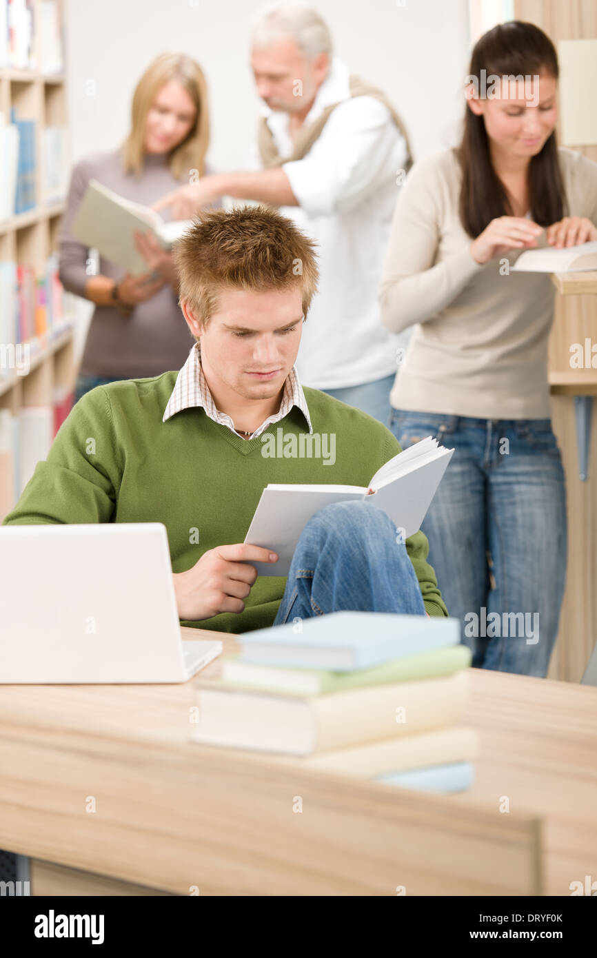 High school library - Student with book Stock Photo - Alamy