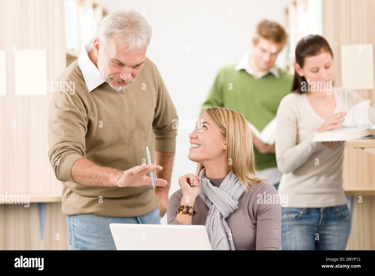 High school library - student with professor Stock Photo - Alamy