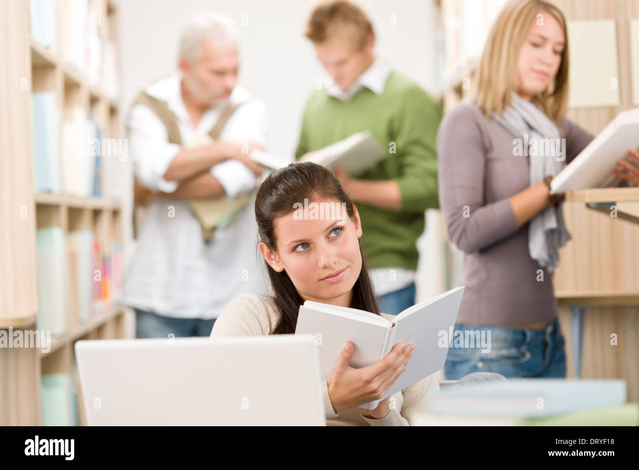 High school library - Student with book Stock Photo - Alamy