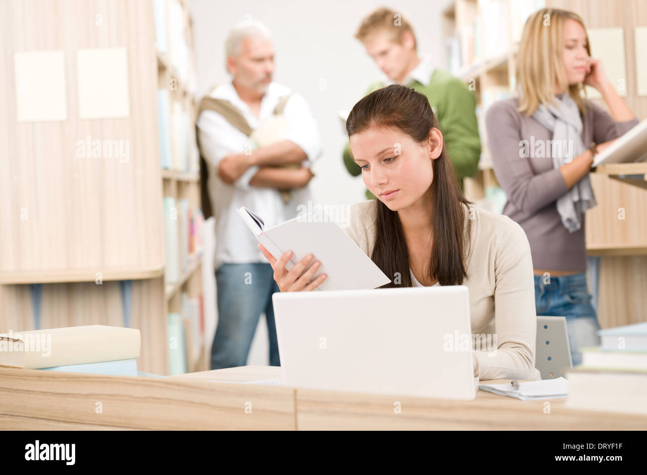 High school library - Student with book Stock Photo - Alamy