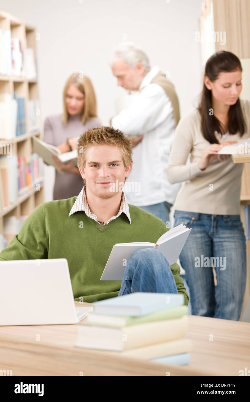 High school library - Student with book Stock Photo - Alamy