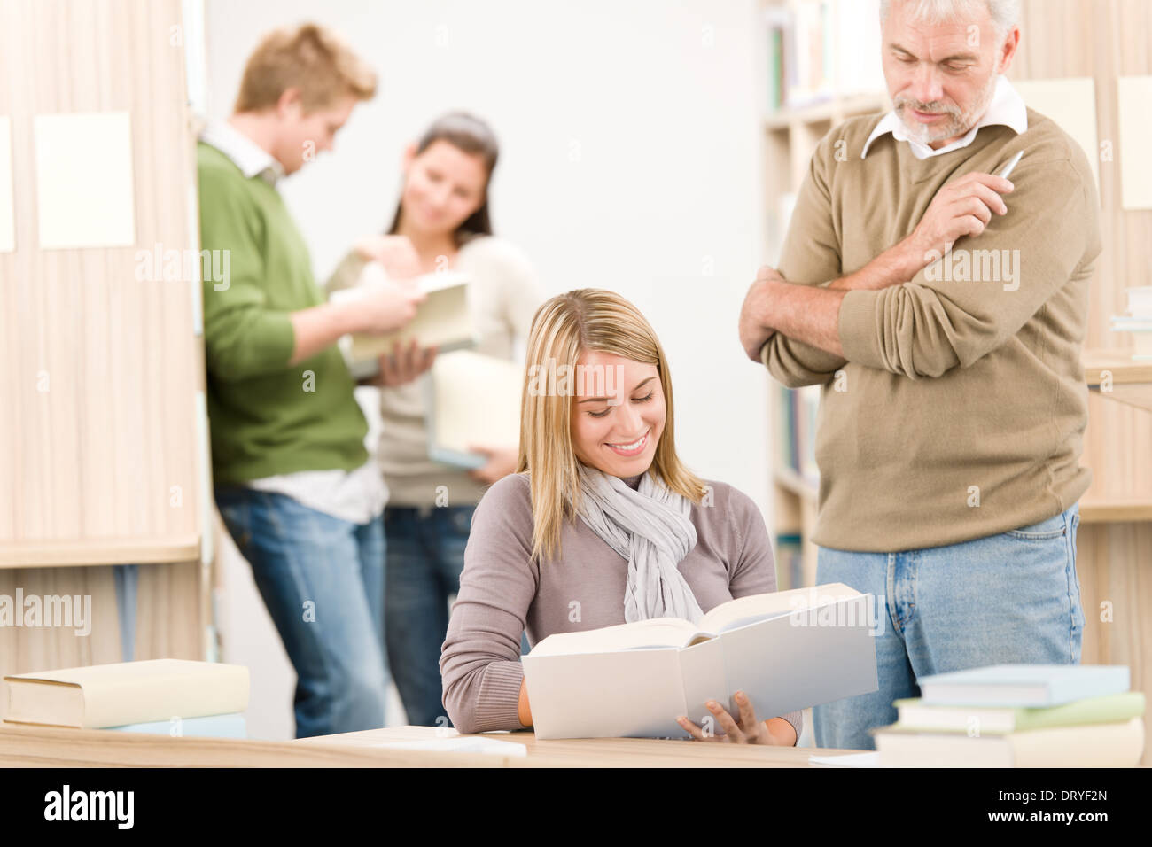 High school library - student with professor Stock Photo - Alamy