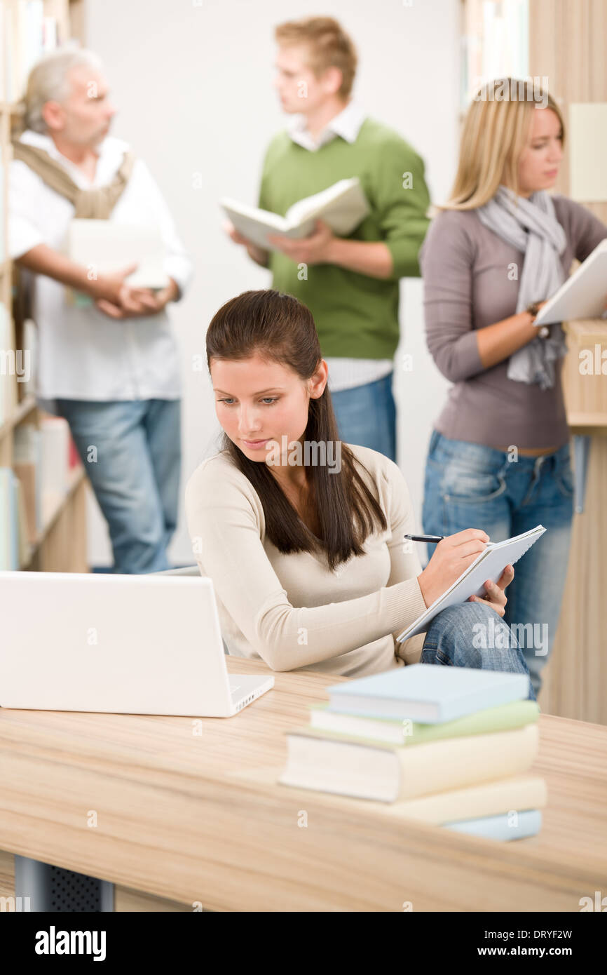 High school library - Student with note pad Stock Photo - Alamy
