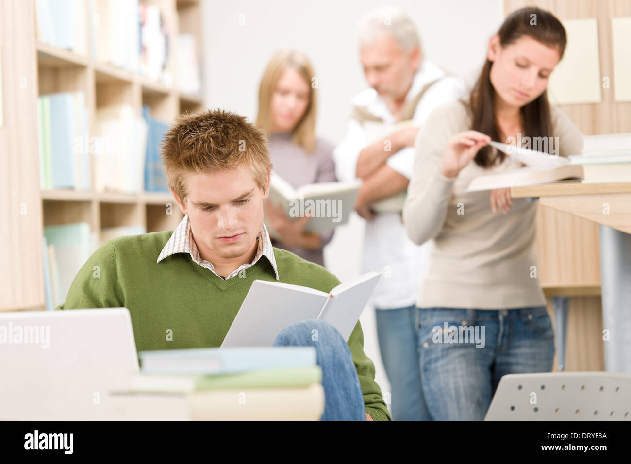 High school library - Student with book Stock Photo - Alamy