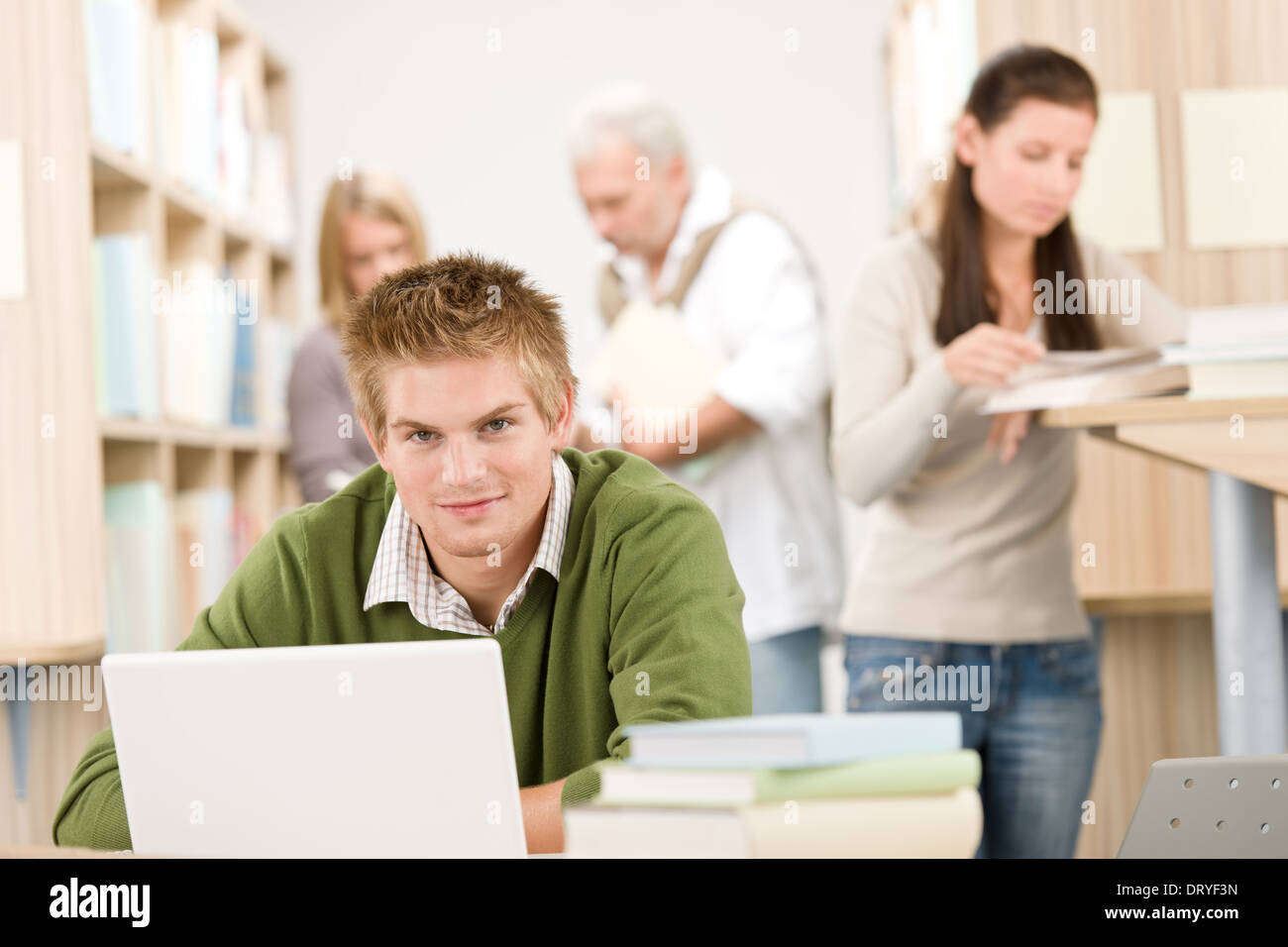 High school library - Student with book Stock Photo - Alamy