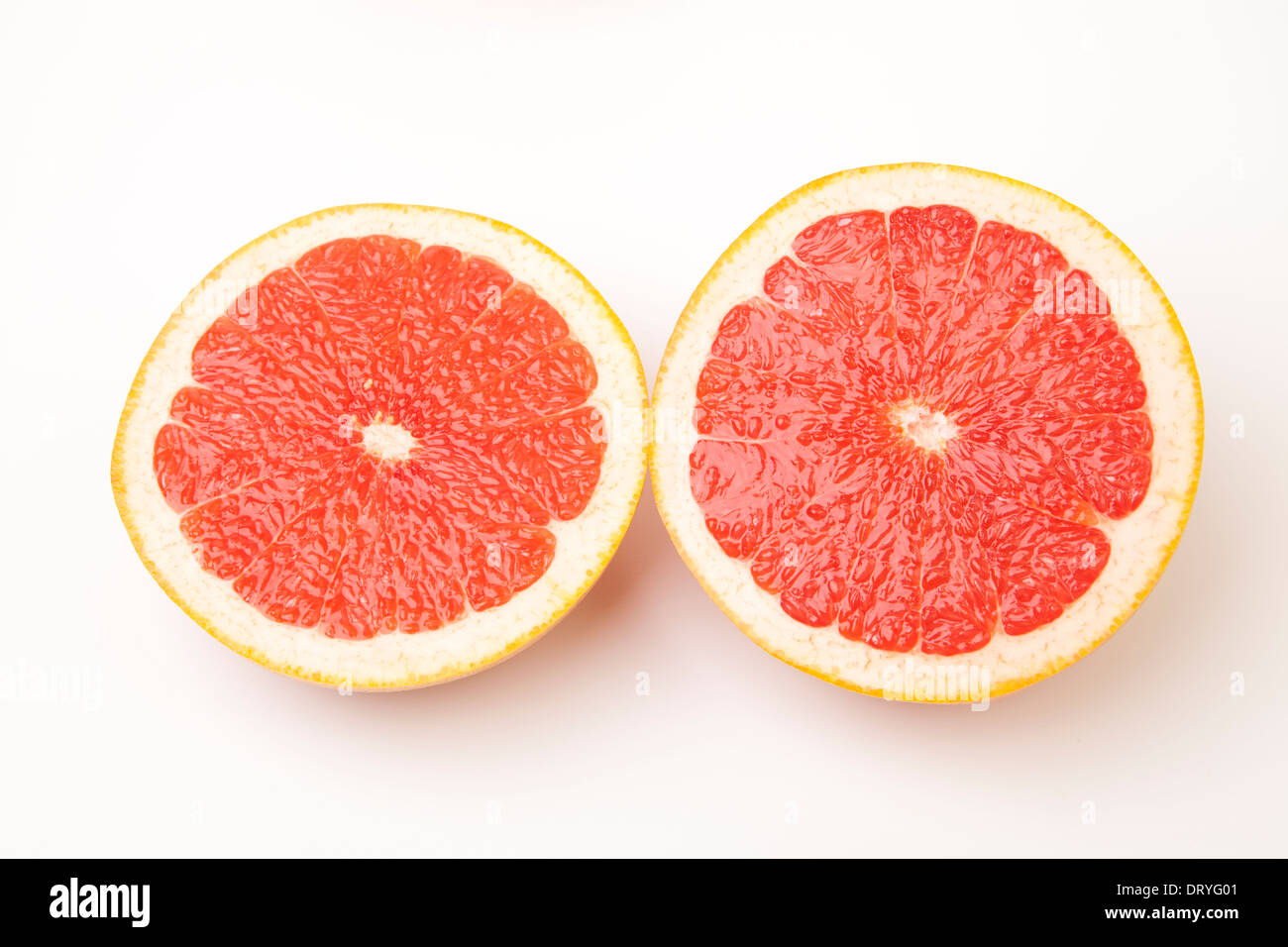 Sliced ruby red grapefruit on white background Stock Photo - Alamy