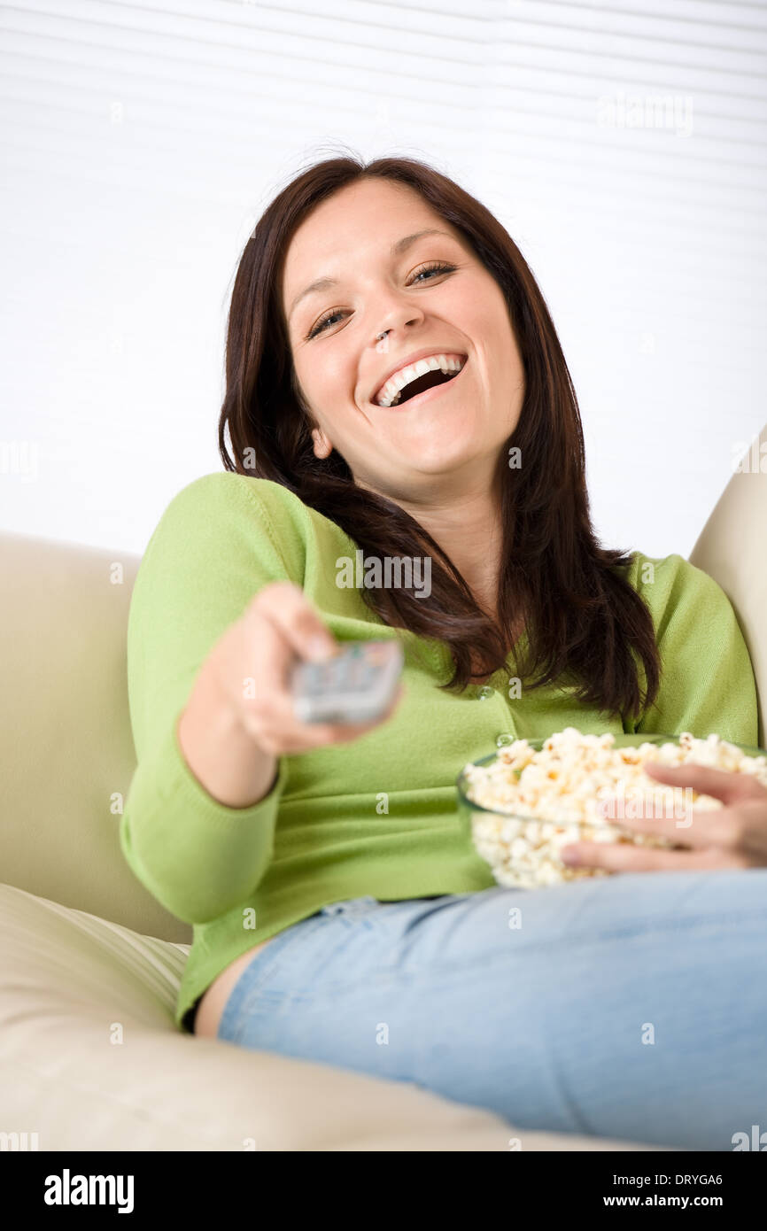Woman pointing with television remote control Stock Photo - Alamy