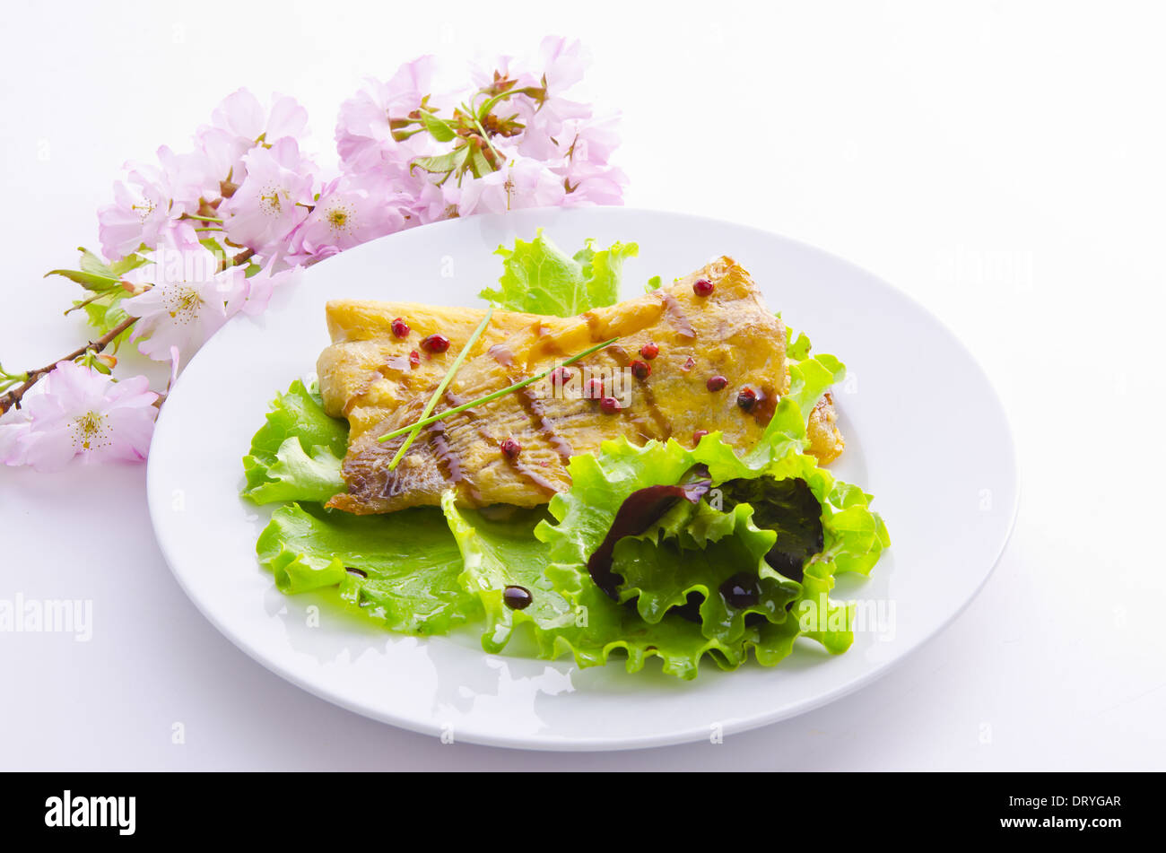 roasted one fish with balsamico cream ones Stock Photo - Alamy