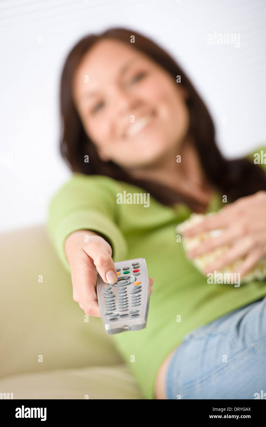 Woman pointing with television remote control Stock Photo - Alamy