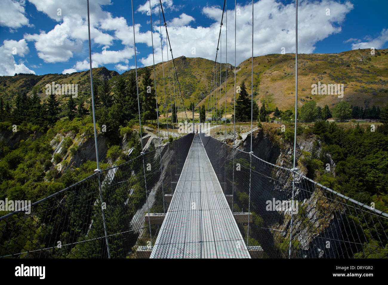 Mountain bikers above the Arrow River on Edgar suspension bridge, Arrow ...