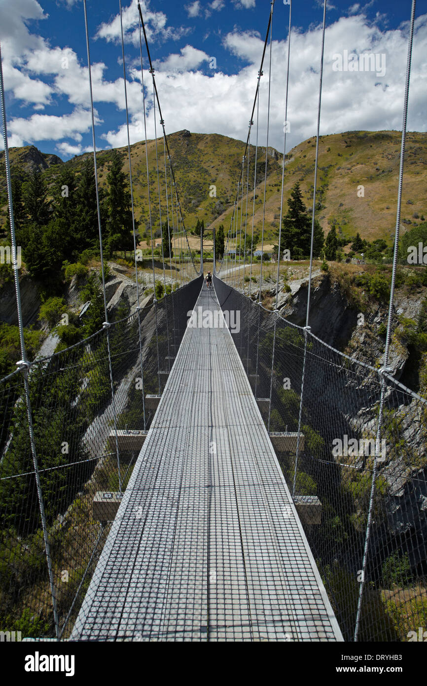 Mountain bikers above the Arrow River on Edgar suspension bridge, Arrow ...