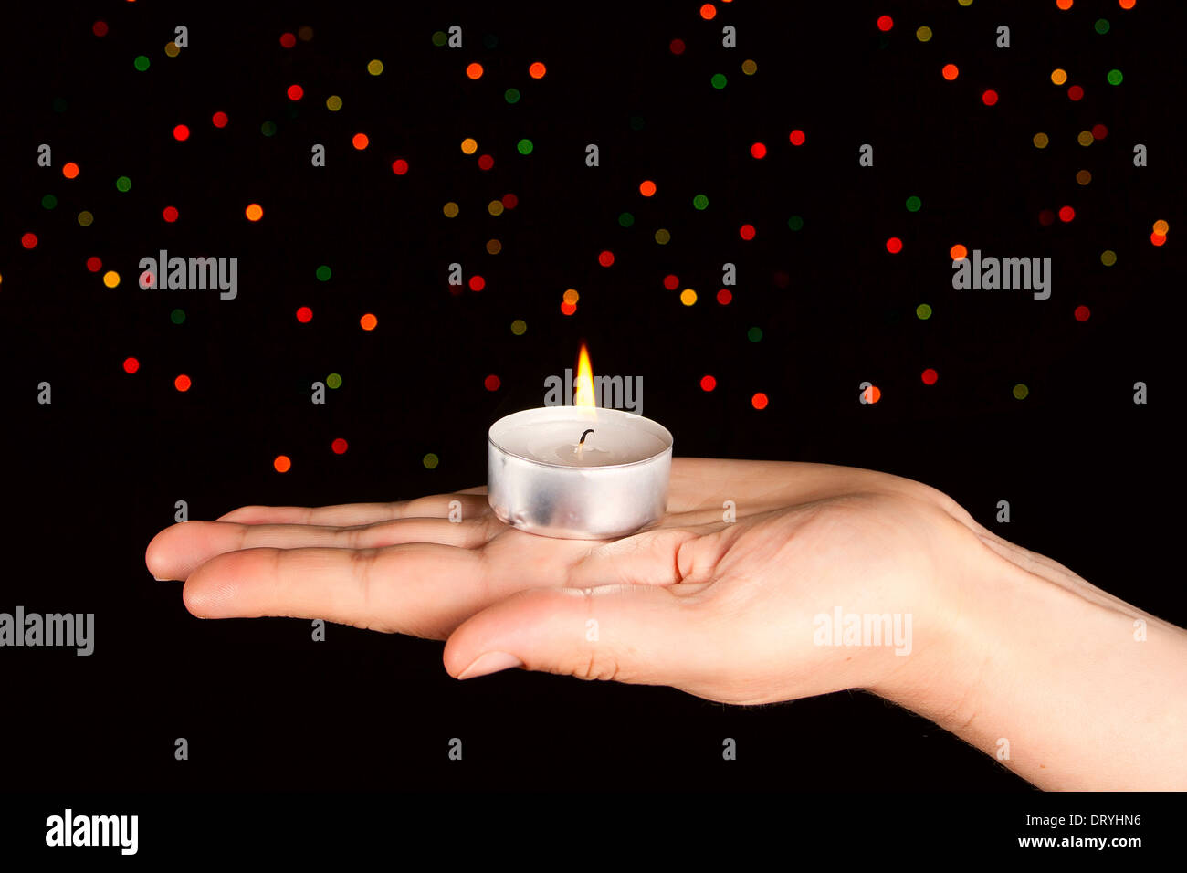 Candle with many-colored sparkles on hand Stock Photo - Alamy