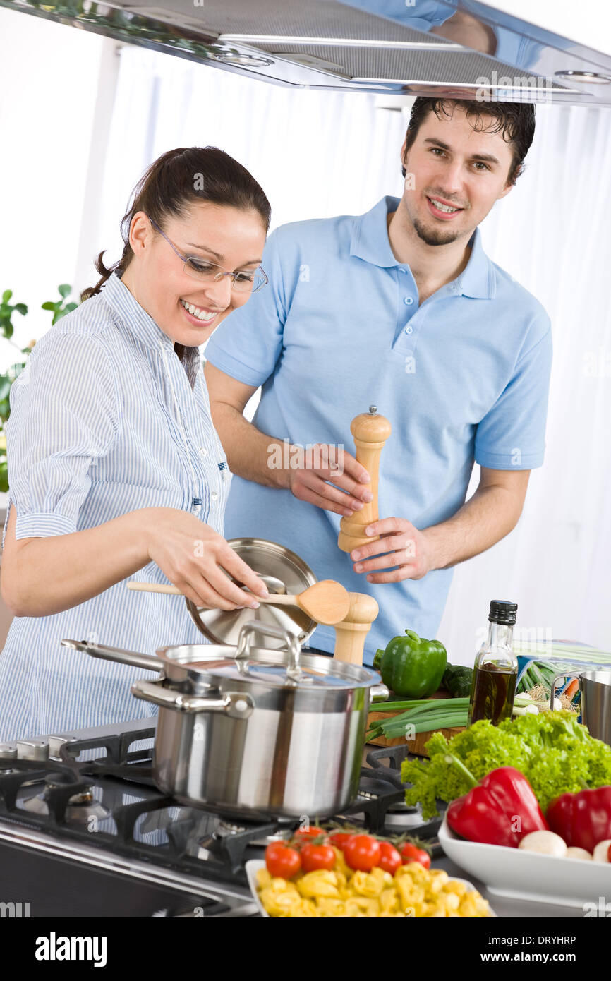 Happy couple cooking in modern kitchen Stock Photo - Alamy