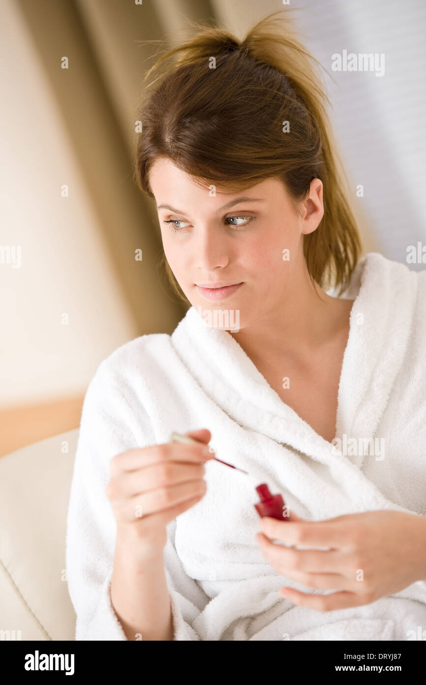 Body care - woman polish nail in bathrobe Stock Photo - Alamy