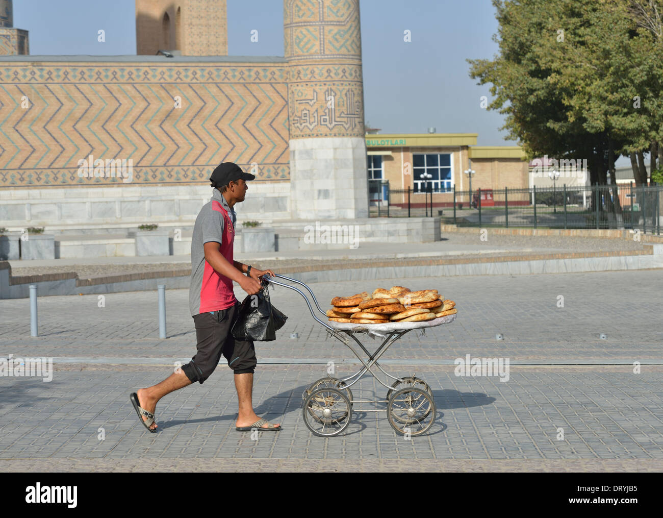 Man carrying bread on a pram to Siyob Bazaar, Samarkand, Uzbekistan ...
