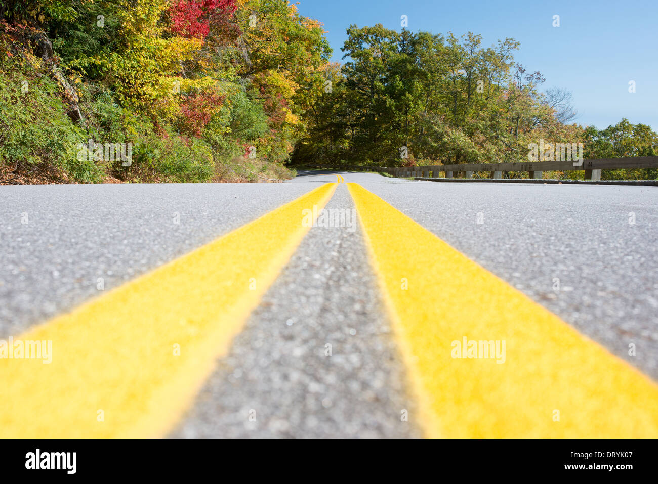 Empty country road with autumn colors and yellow center lines Stock ...