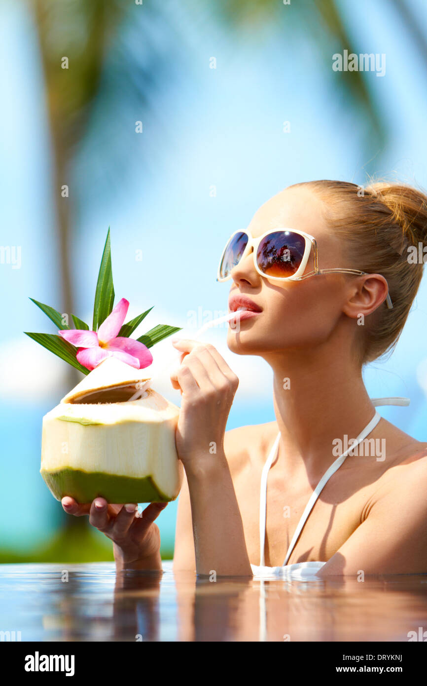Woman drinking tropical cocktail Stock Photo - Alamy