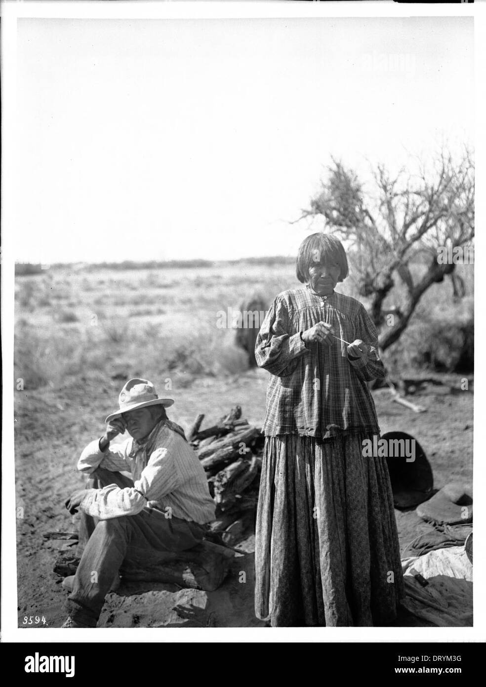 An Apache Indian man and woman are photographed at their camp in 1903 ...