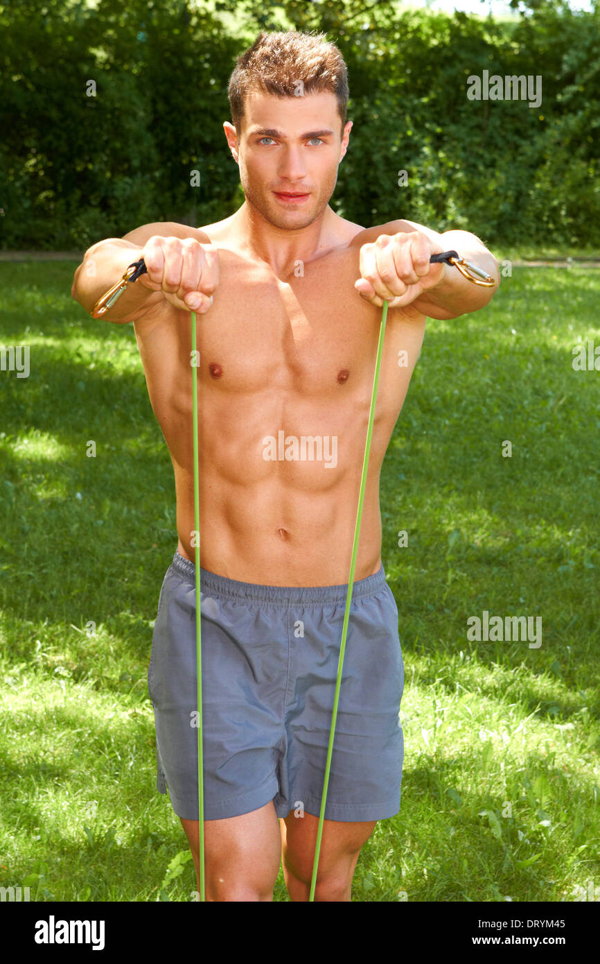 Muscular Male Improving his strength Stock Photo - Alamy