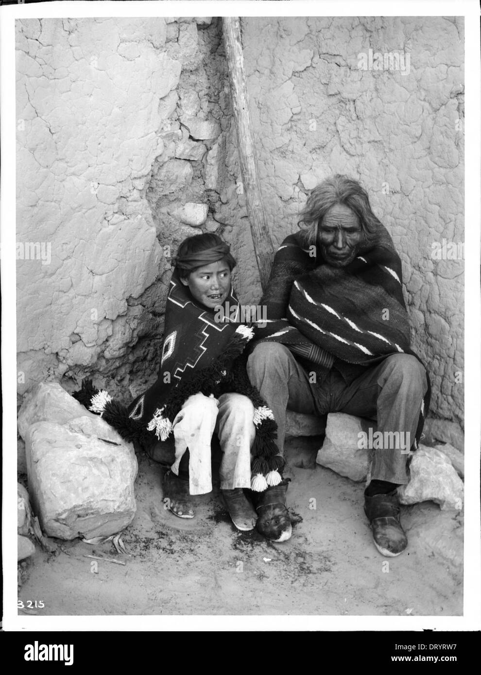 An old Navajo brave and his nephew, both huddled in their blankets, ca ...