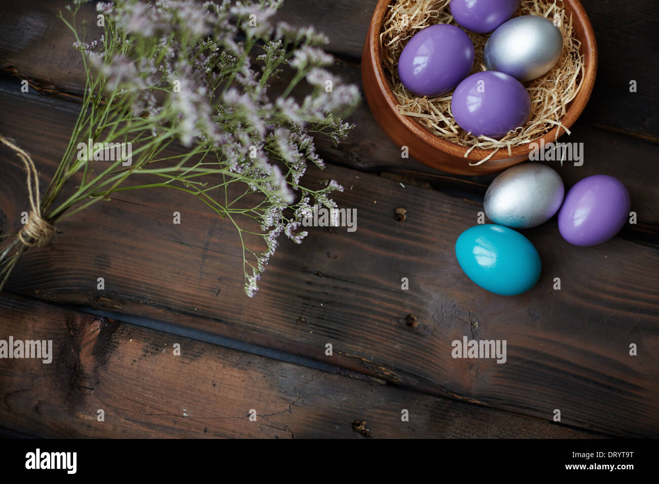 Colorful Easter eggs and dry flowers near by Stock Photo - Alamy