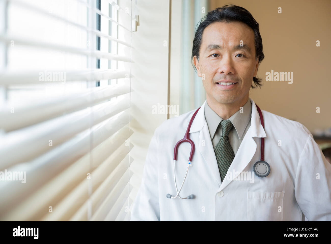 Doctor With Stethoscope Around Neck In Hospital Room Stock Photo - Alamy