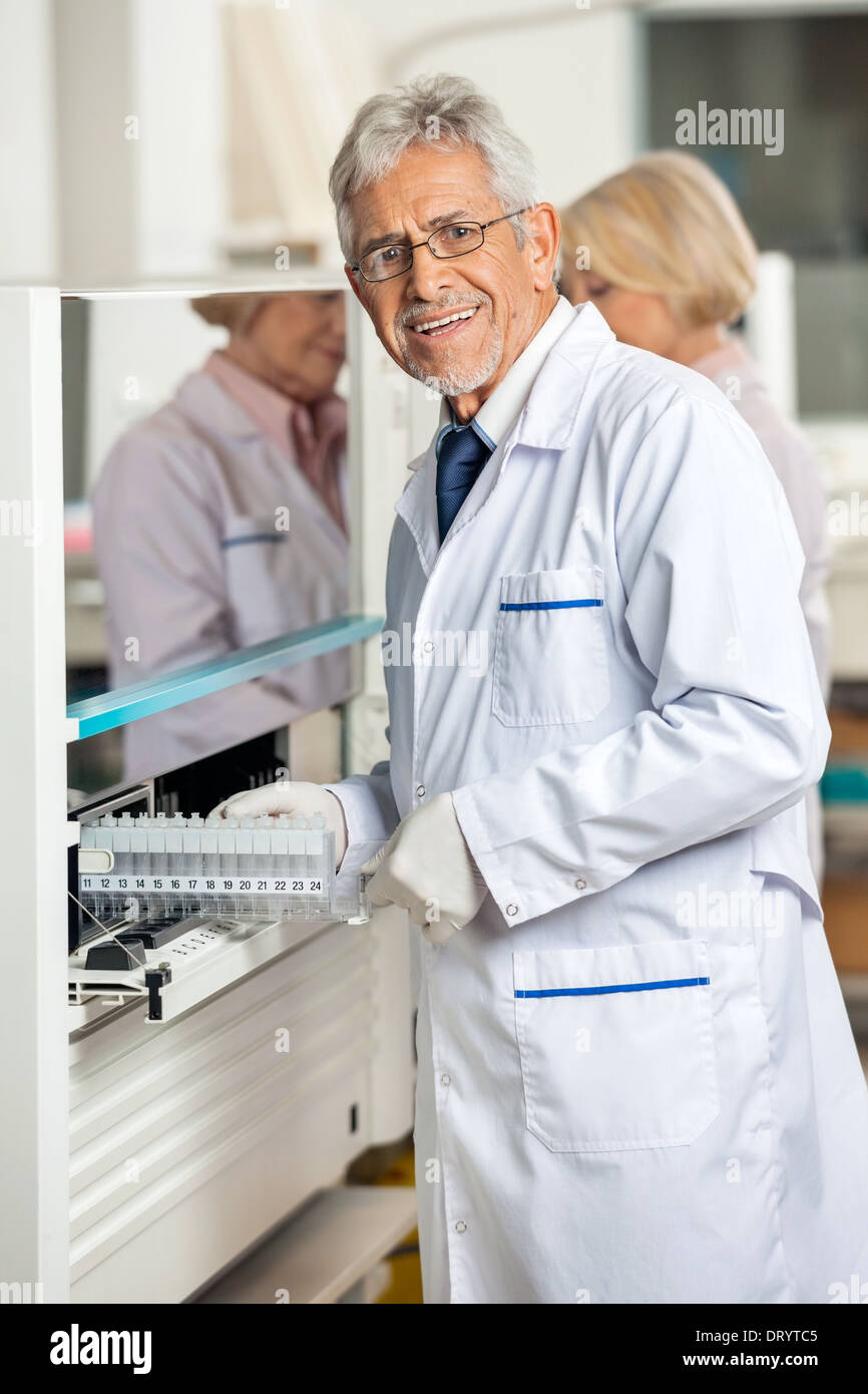 Researcher Loading Samples In Analyzer Stock Photo - Alamy