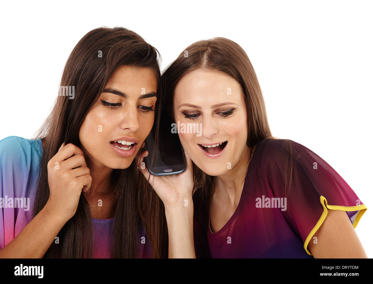 Portrait of two friends having fun using the mobile phone isolated on ...
