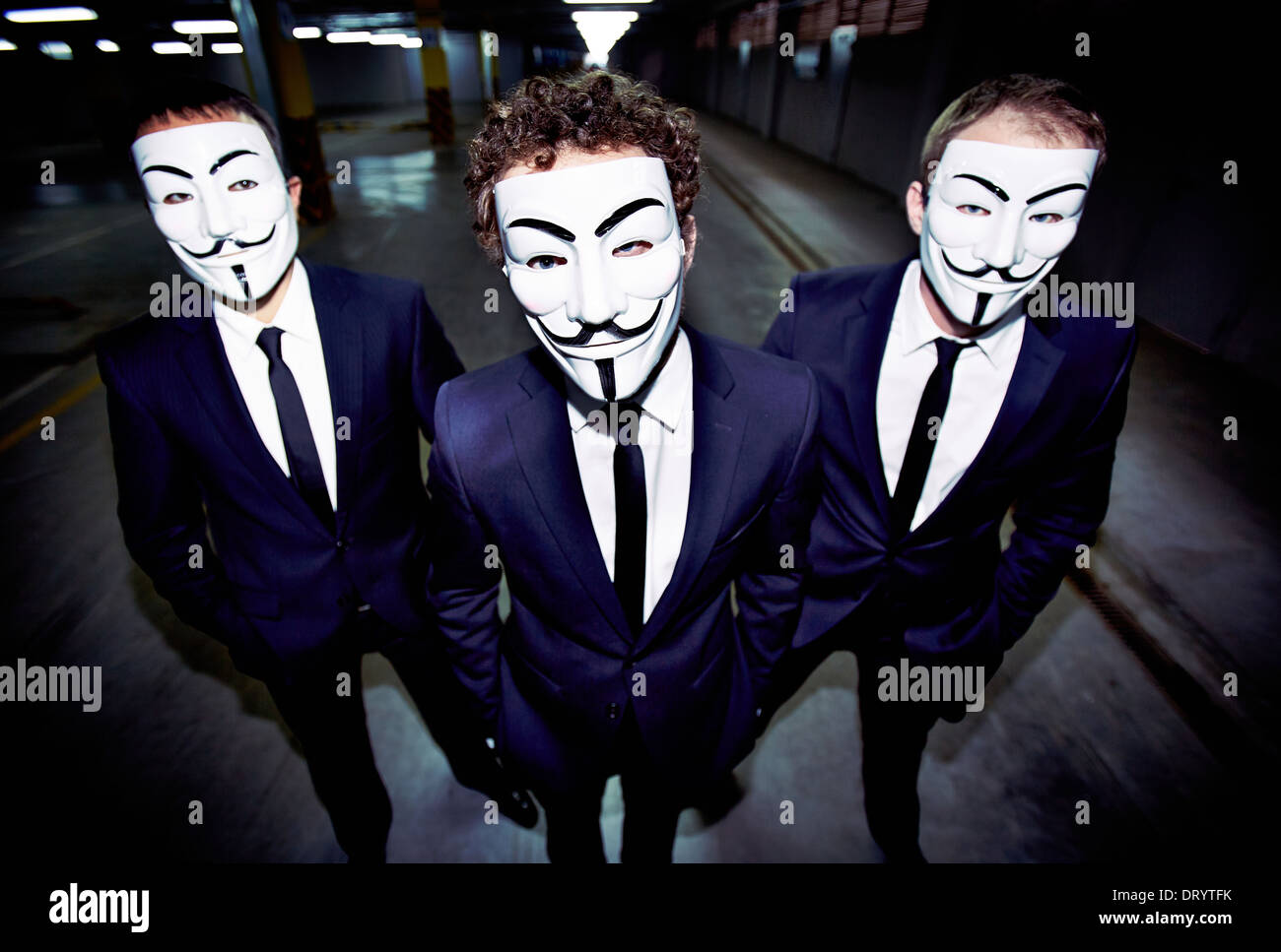 Portrait of three guys in Guy Fawkes masks with intense looks and ...