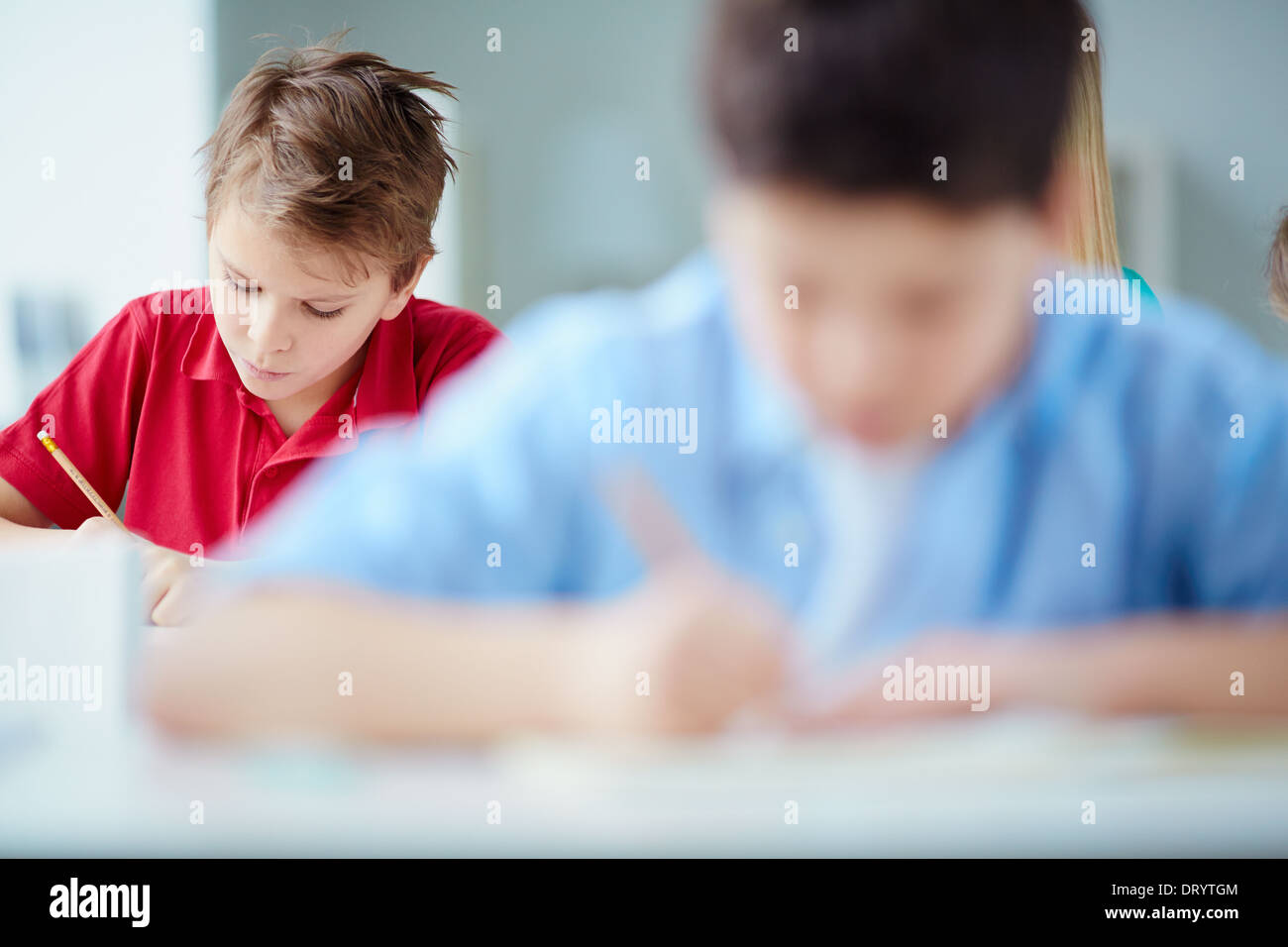 Portrait of serious schoolboy drawing at lesson Stock Photo - Alamy