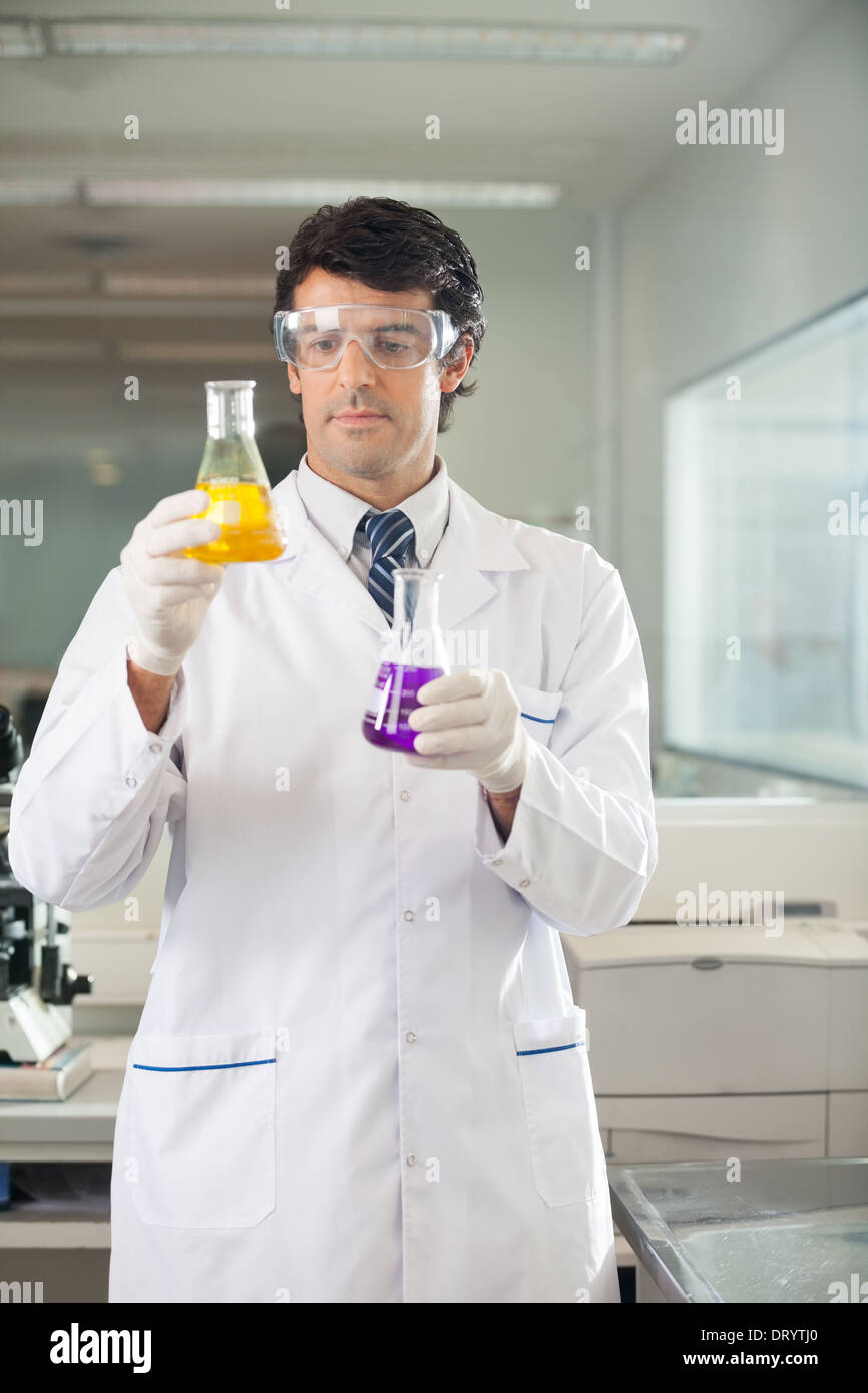 Scientist Examining Flasks With Different Chemicals Stock Photo - Alamy
