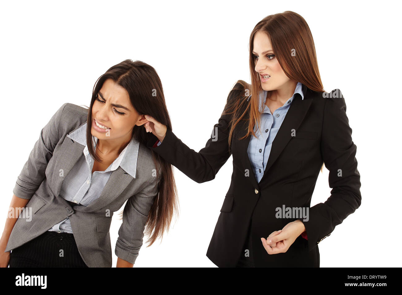 Portrait of businesswoman pulling colleague's ear isolated on white ...