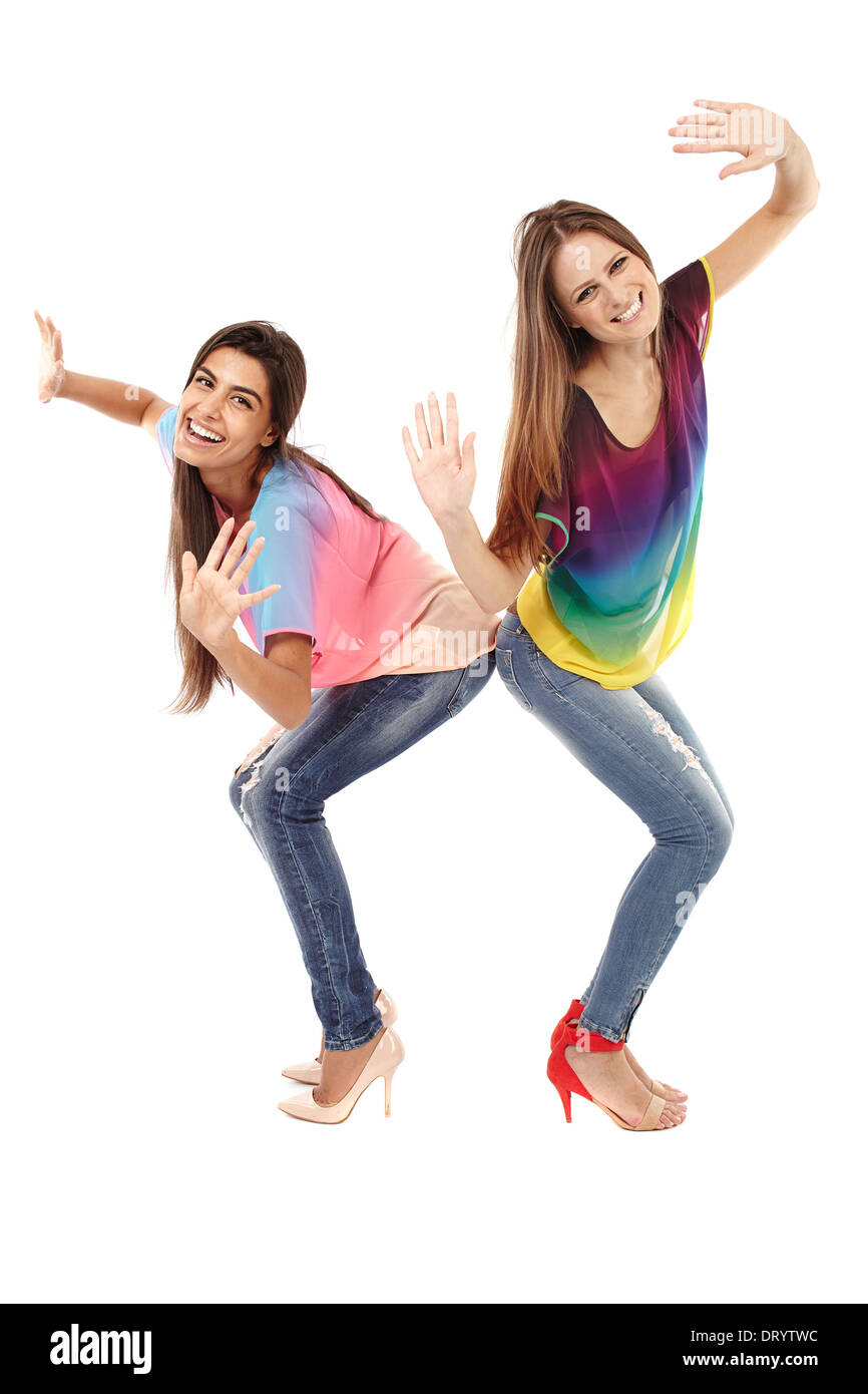 Portrait of two girlfriends playing and having fun isolated on white ...