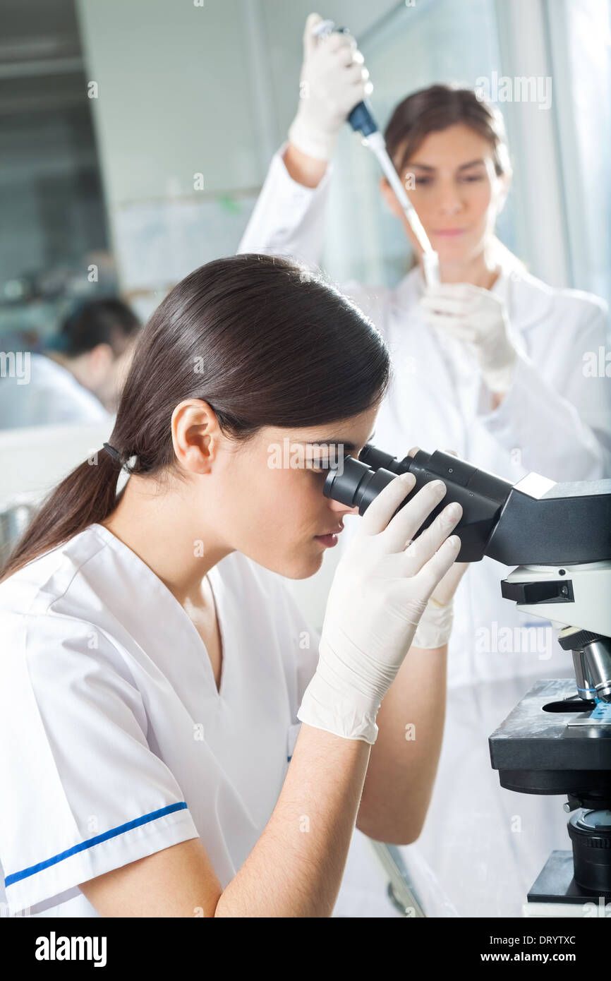 Female Researcher Using Microscope Stock Photo - Alamy