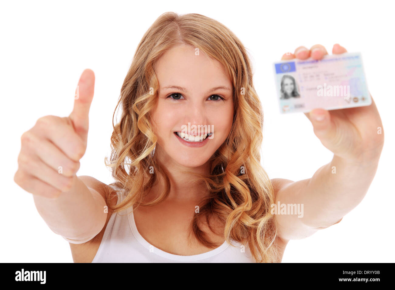 Attractive girl proudly showing her drivers licence. All on white ...