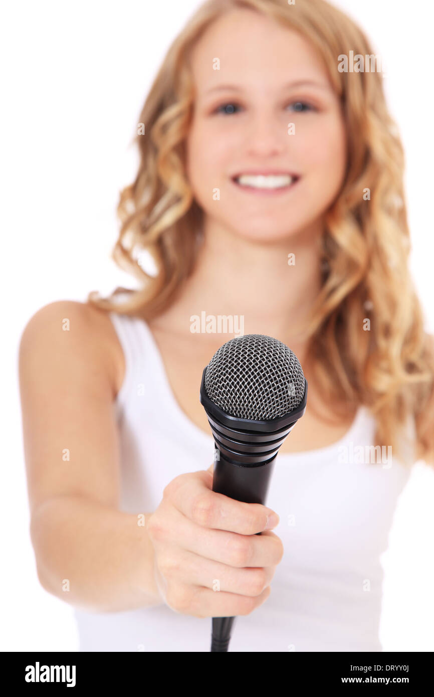 Attractive girl holding microphone. All on white background Stock Photo ...