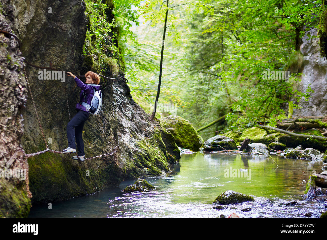 Woman climbing over wall hi-res stock photography and images - Alamy