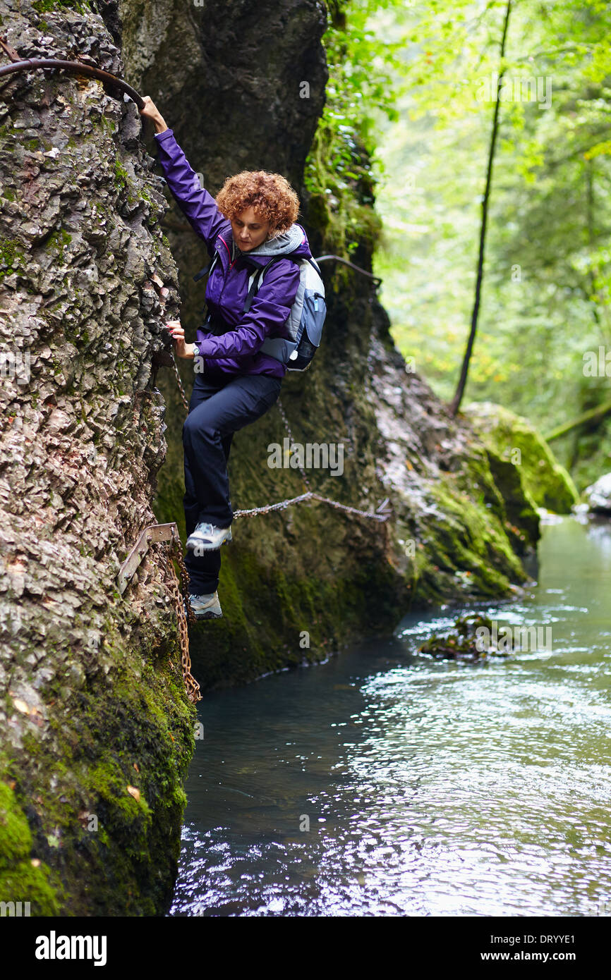 Woman climbing over wall hi-res stock photography and images - Alamy