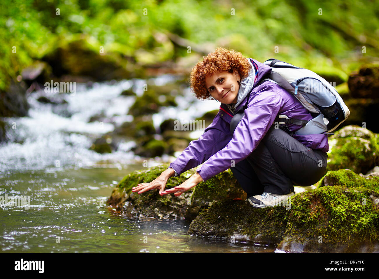 Female tourist washing hands in a mountain river Stock Photo - Alamy