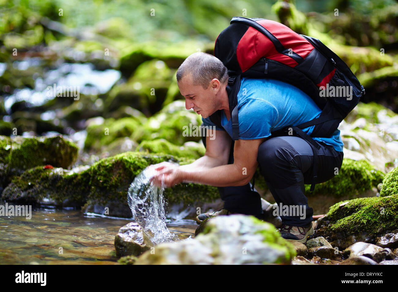 Tourist washing hands in a mountain river Stock Photo - Alamy