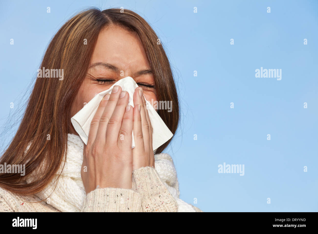 Attractive woman using tissue Stock Photo - Alamy