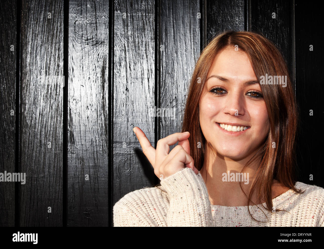 Attractive girl points to the side Stock Photo - Alamy