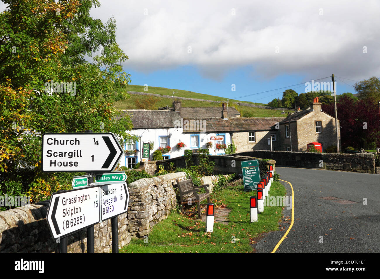 A village with stone cottages and road signs and a Dales Way sign Stock ...