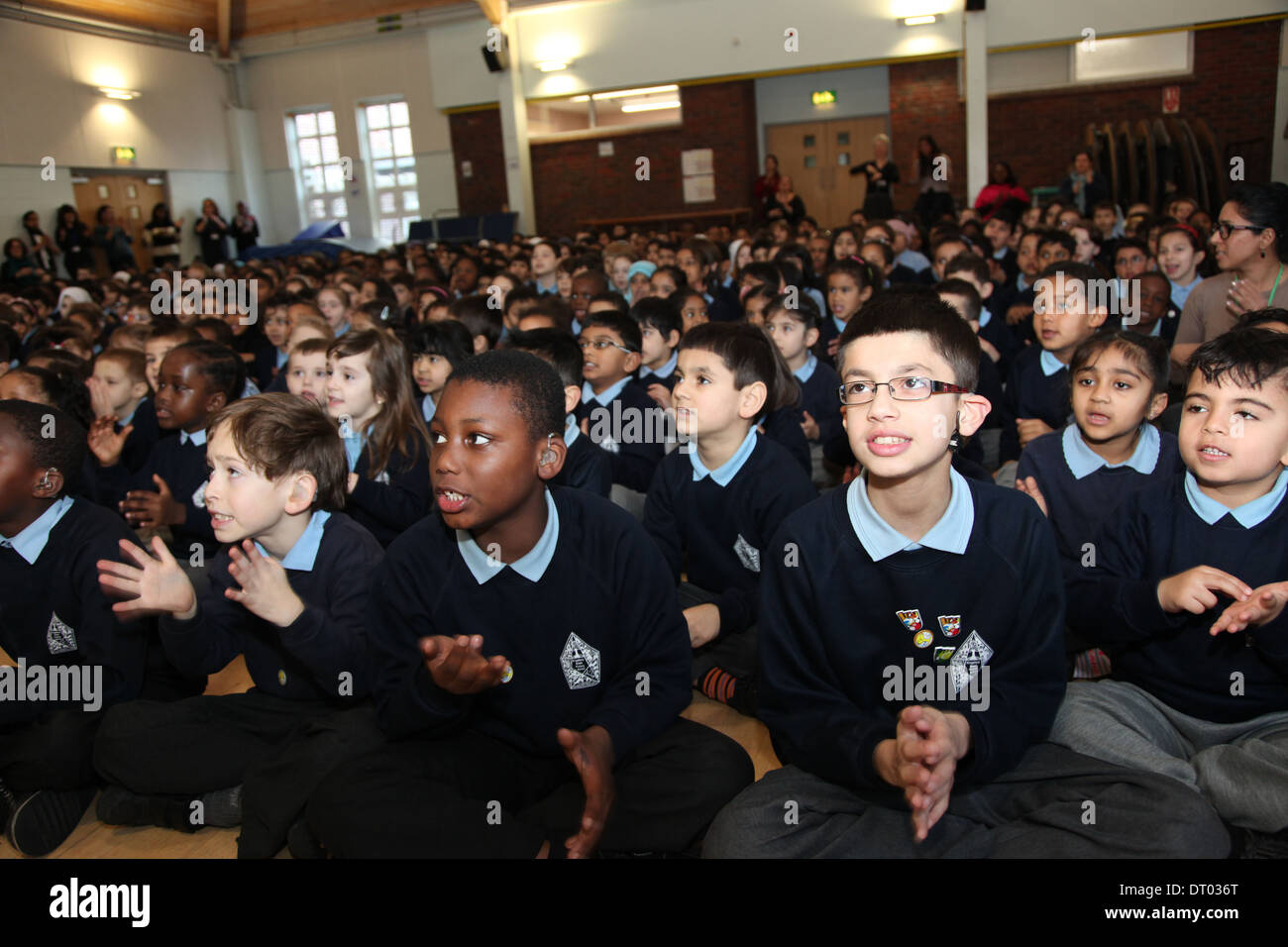 Children singing and performing sign language at a school assembly ...