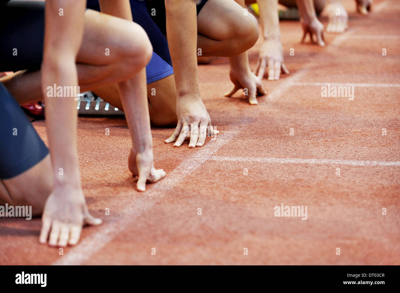 Athletes at the sprint start line in track and field Stock Photo - Alamy