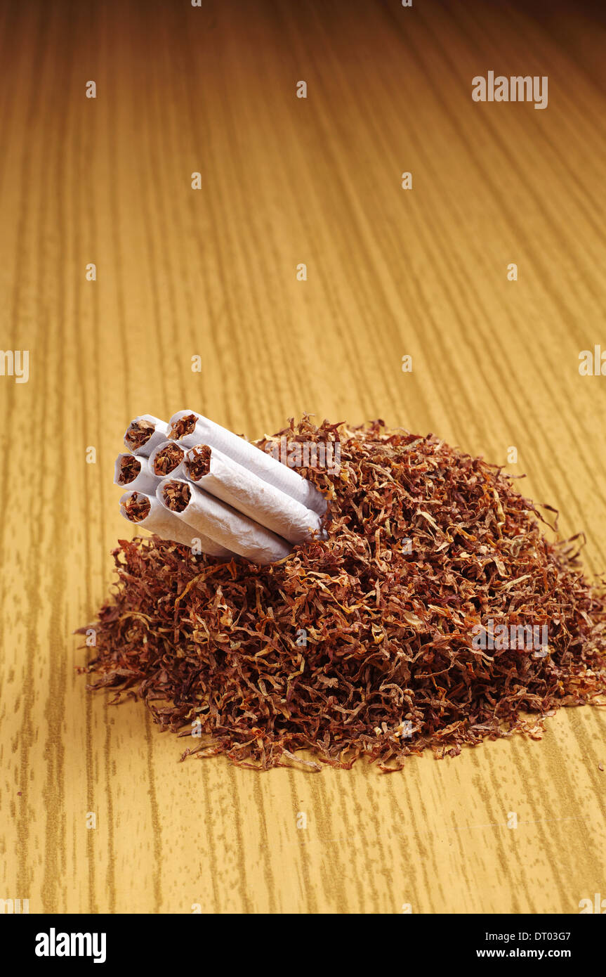 Tobacco and hand rolled cigarettes on table Stock Photo - Alamy