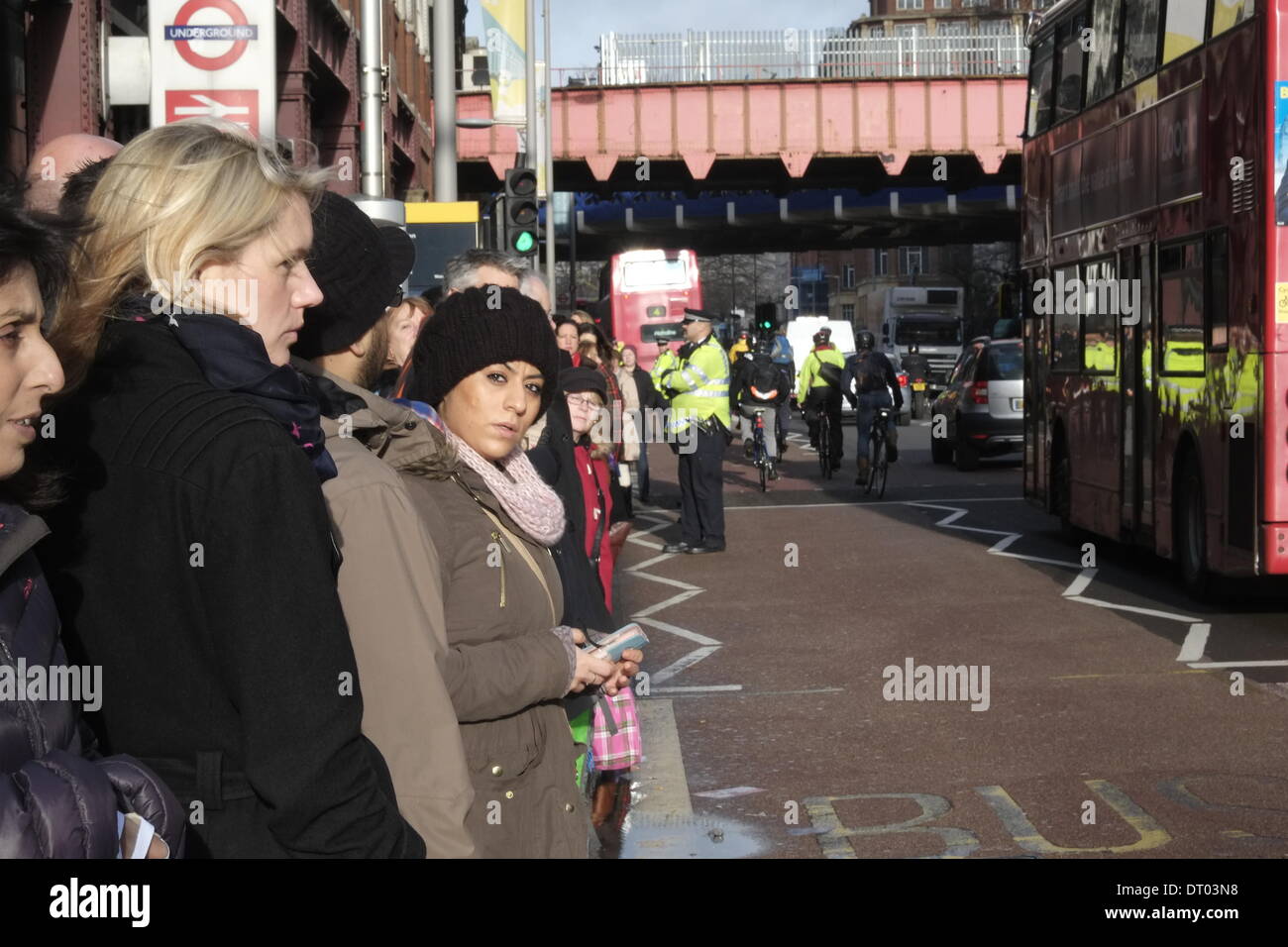 London, UK . 05th Feb, 2014. Police control crowds waiting for buses at ...