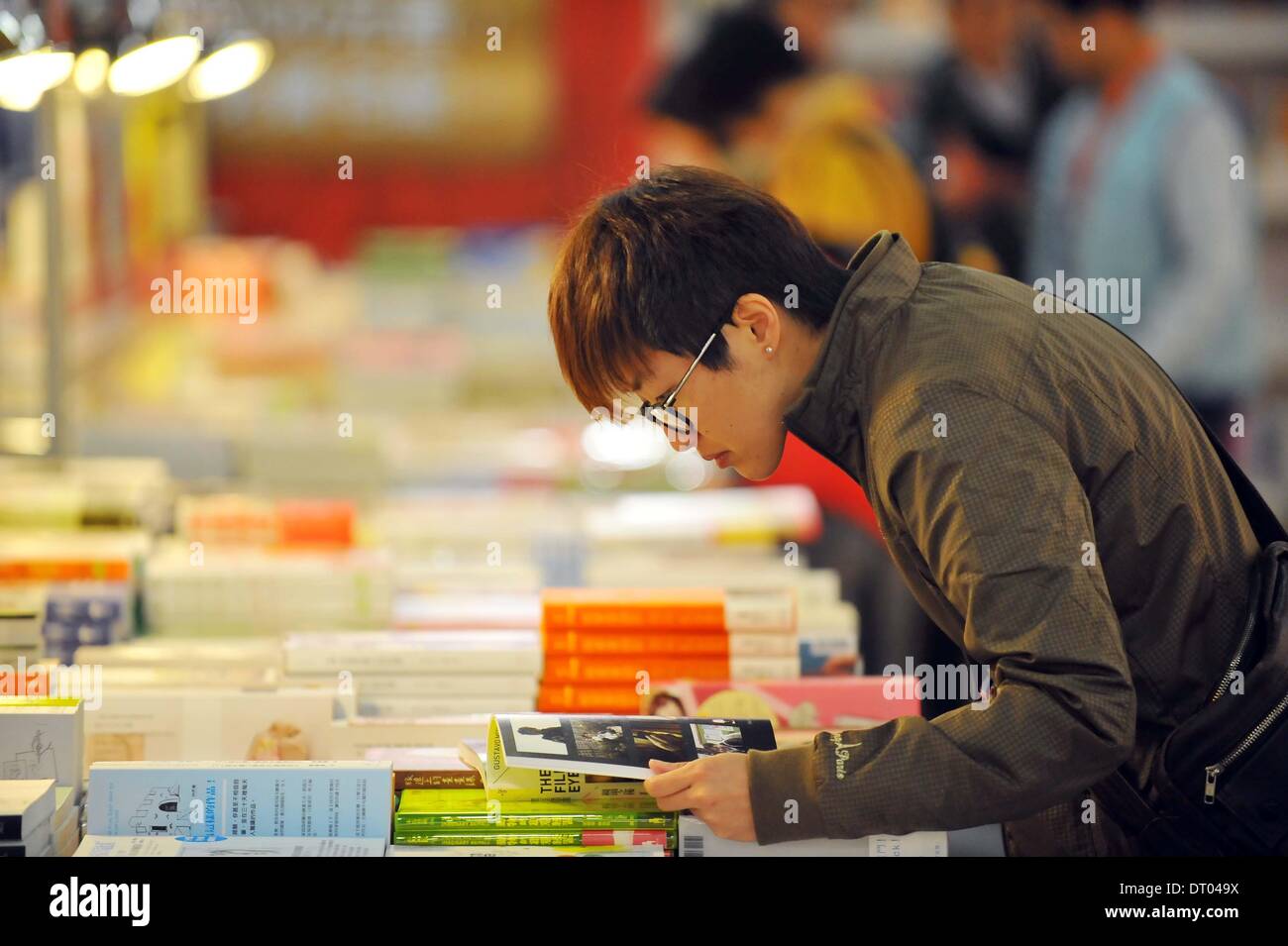 Taipei, China's Taiwan. 5th Feb, 2014. A visitor reads a book at a book ...